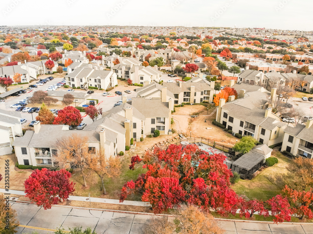 Beautiful aerial view of apartment complex near local street with ...
