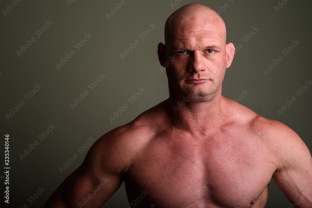 Bald muscular man shirtless against colored background Stock Photo ...
