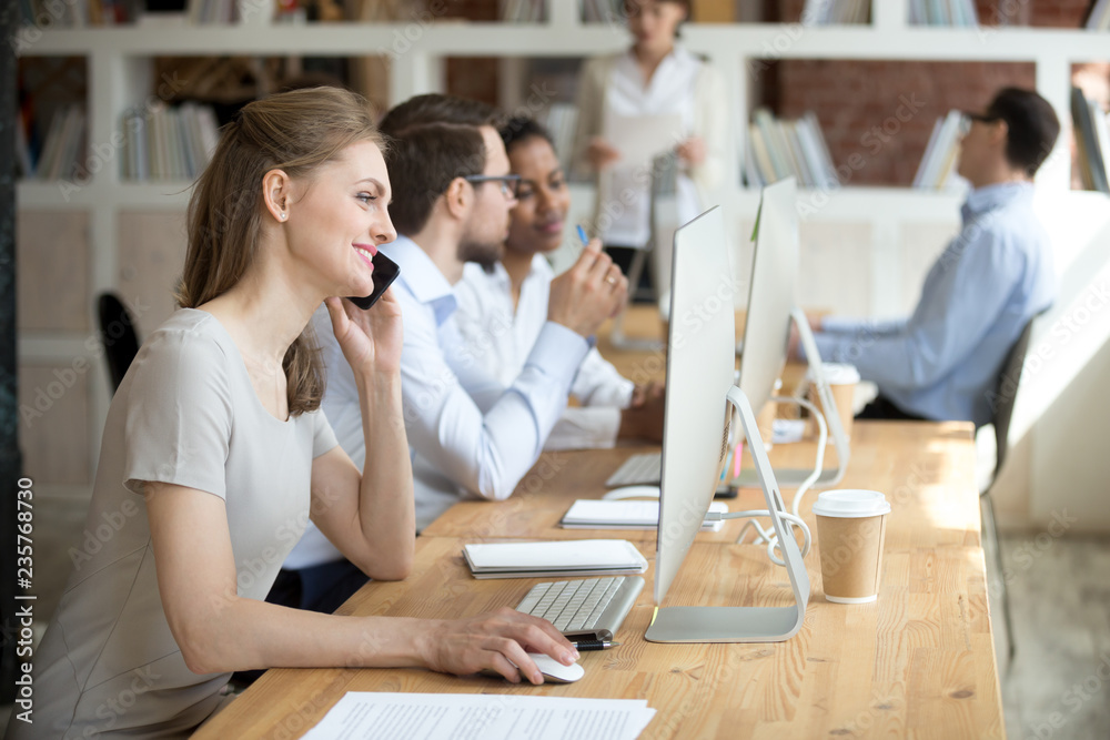 Confident female employee talking, consulting by phone with client ...