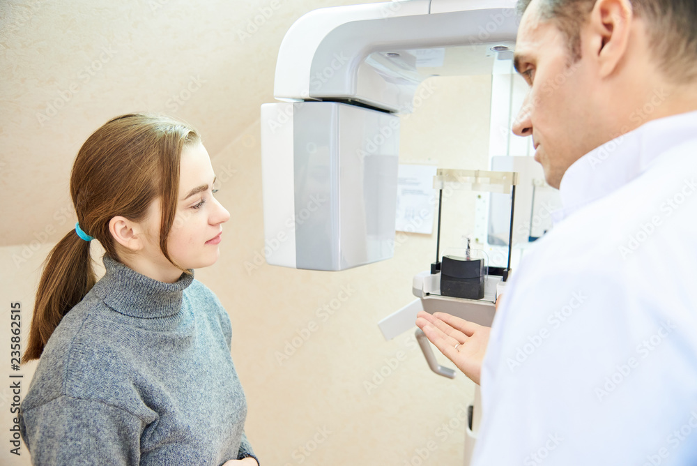 dental tomography. The doctor tells the patient what to do, both are ...
