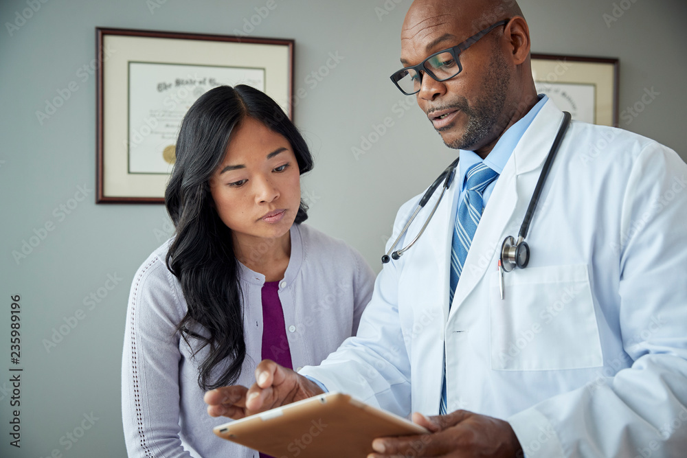Doctor and patient review medical results Stock Photo | Adobe Stock