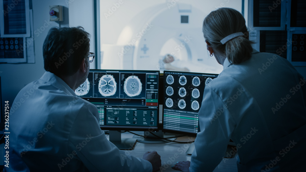 In Control Room Doctor and Radiologist Discuss Diagnosis while Watching ...