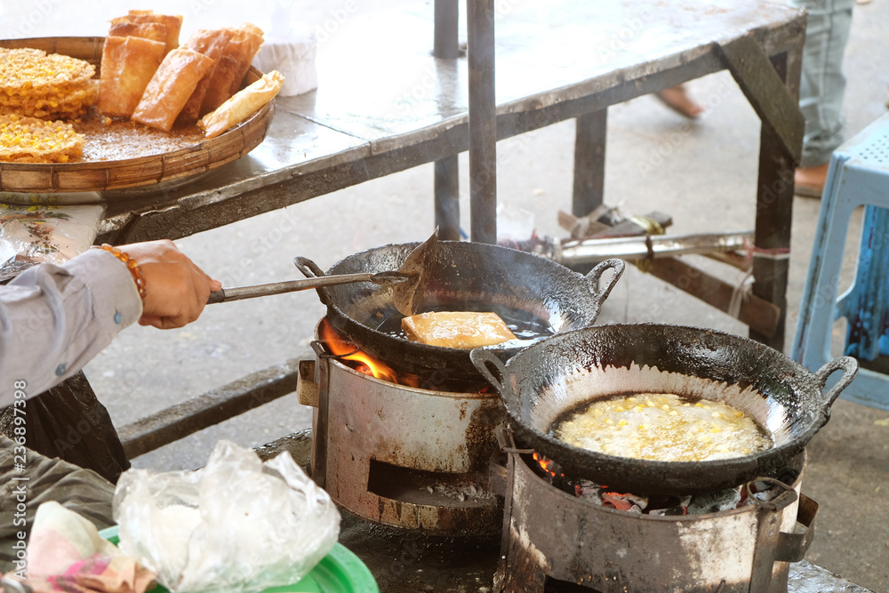 Cooking of Burmese deep fried snack known as Bayar Kyaw at the street ...