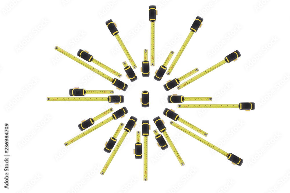 Spiral of yellow and black steel rules measures different lengths with ...