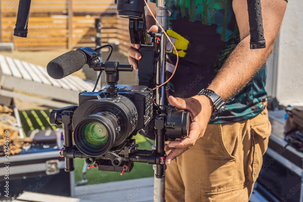 Steadicam operator prepare camera and 3-axis stabilizer-gimbal for a ...