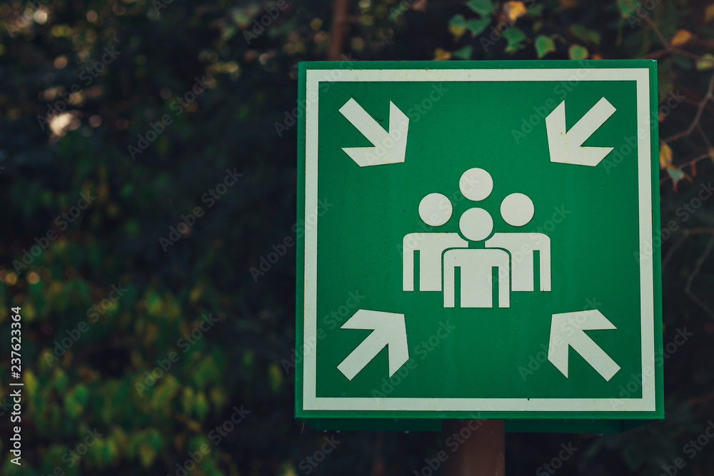 Green assembly point or meeting sign close up in nature. Meeting place ...