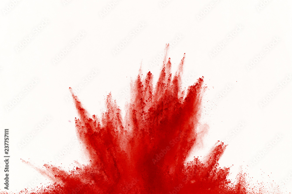 Freeze motion of red powder exploding, isolated on white background ...