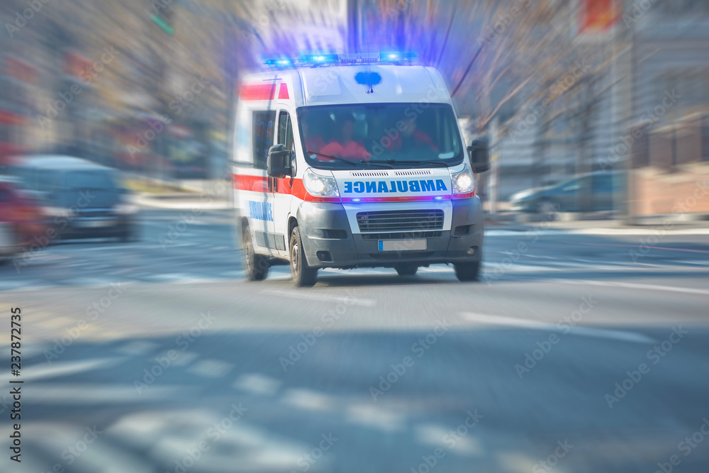 Paramedic 911 ambulance car running fast through the big city. Stock ...