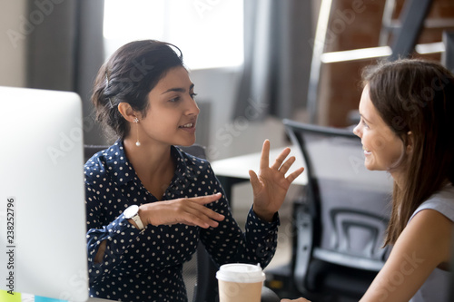 Friendly female colleagues having good relationships, pleasant ...