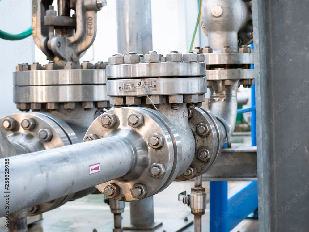 series of joints with flanges and bolts on an industrial pipe line ...