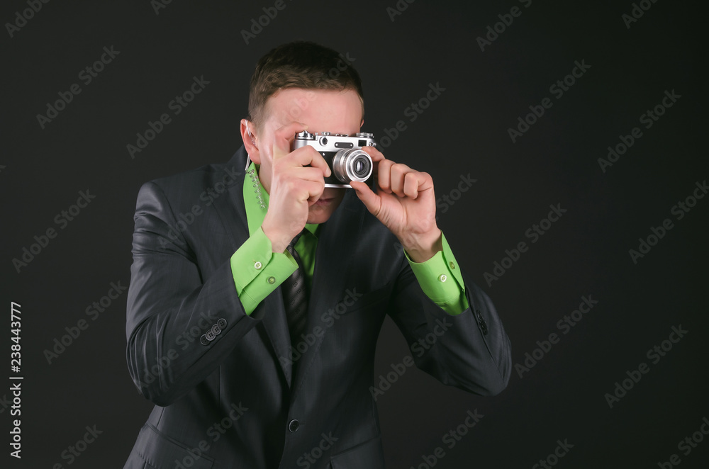 Spy secret service agent with photo camera is photographing a ...