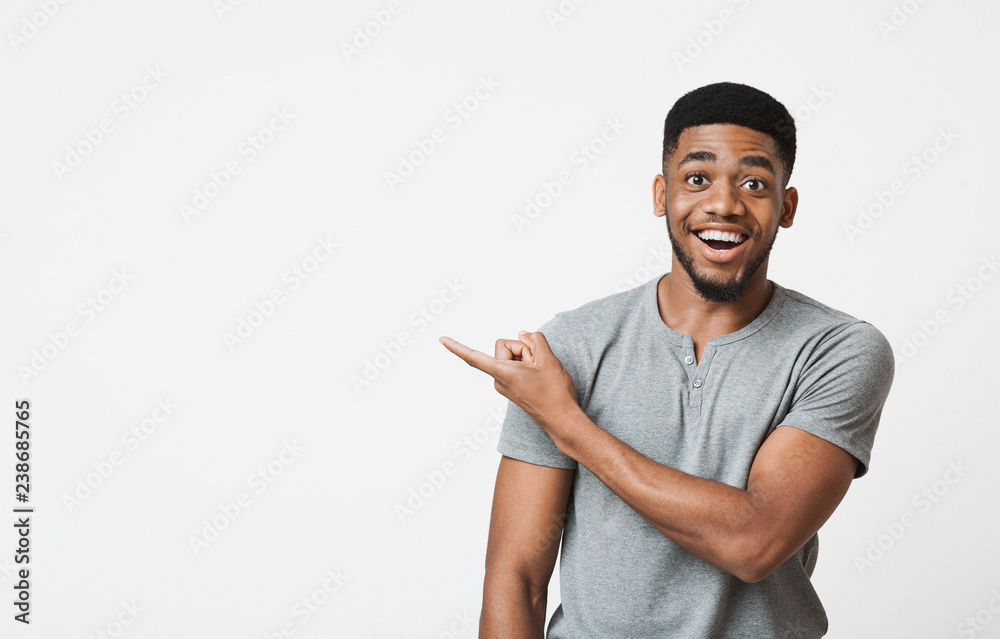 African-american man pointing aside at copy space Stock Photo | Adobe Stock