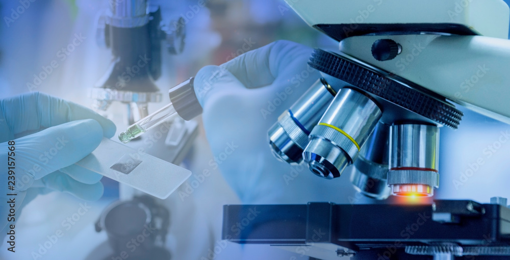 Close up shot of microscope equipment with metal lens in laboratory ...