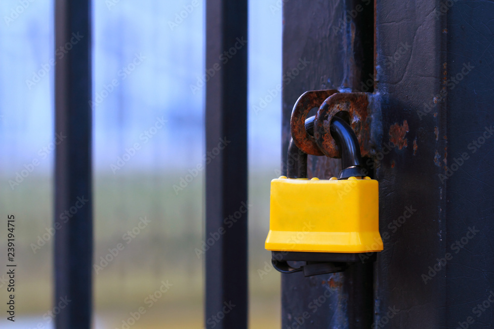 Gate is locked with padlock. Yellow lock on the fence. Closed area ...