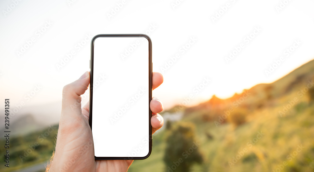 Hand of holding smartphone with white screen on nature background Stock ...