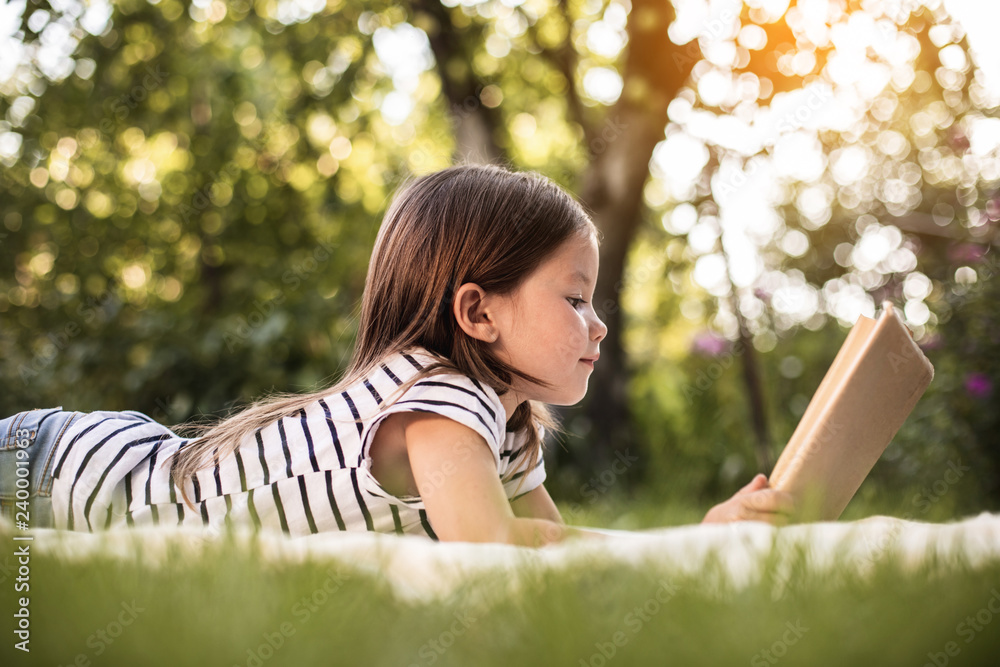 Little girl resting at park in summer Stock Photo | Adobe Stock