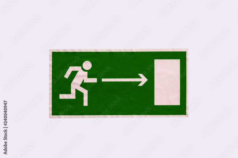 emergency exit sign, a running white man on a green background and an ...