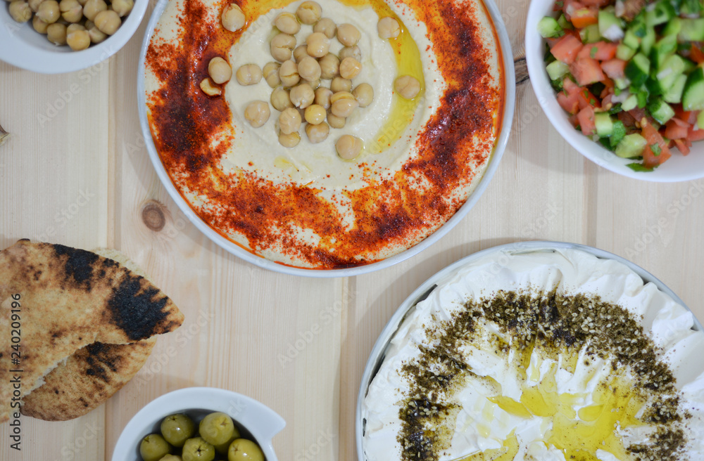 plates of Traditional homemade hummus with red paprika olive oil garlic ...