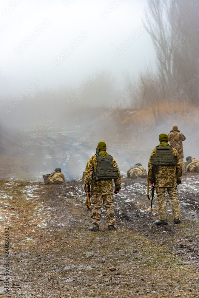 The military in the position for firing a Kalashnikov assault rifle in ...
