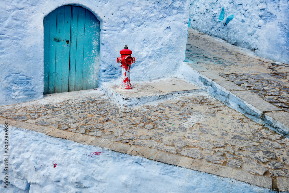 red fire hydrant on the street in blue city Chefchaouen in Morocco ...