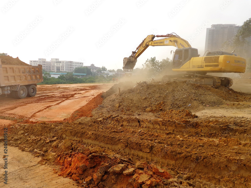 Heavy machinery doing earthwork at the construction site. Works carried ...