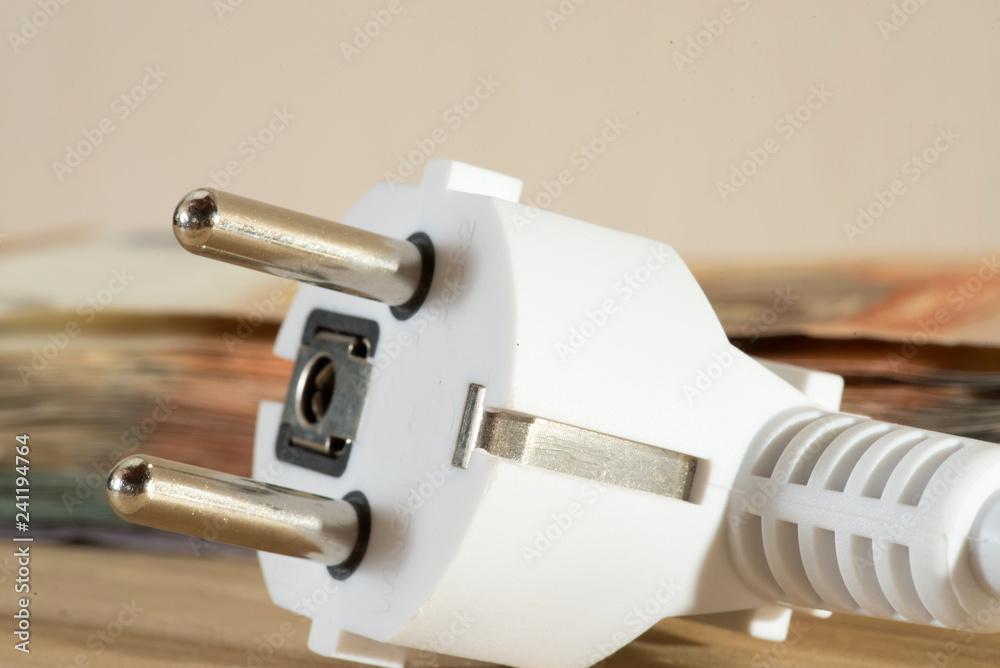 Ein Stromstecker und Euro Geldscheine Stock Photo | Adobe Stock