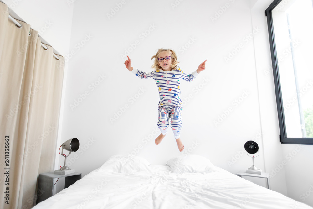 Little girl in pajamas jumping on bed Stock Photo | Adobe Stock Little girl in pajamas jumping on bed Stock Photo | Adobe Stock