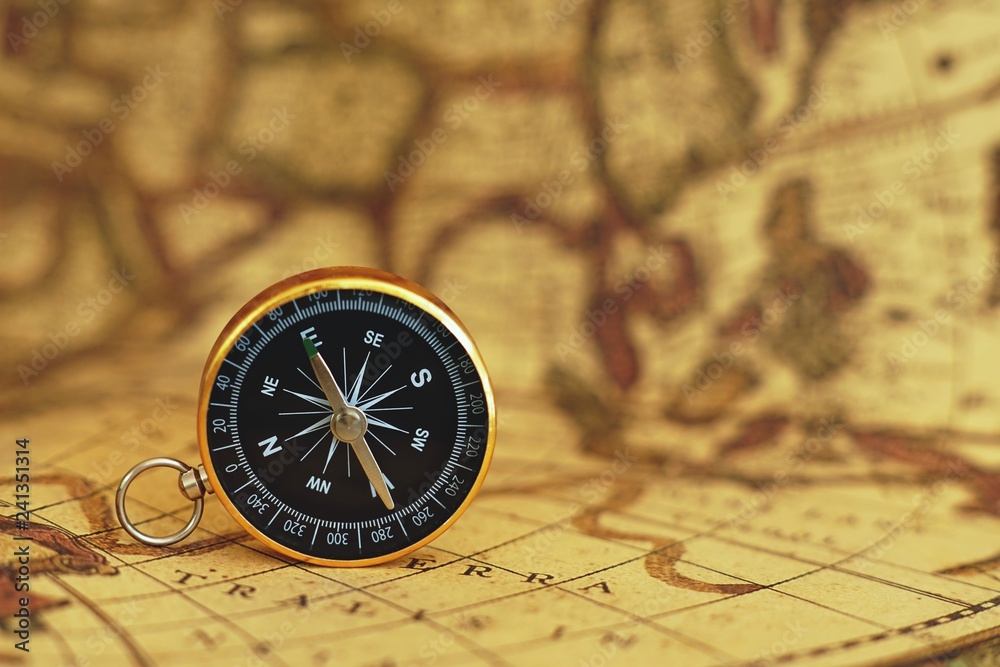 Compass on blur vintage map background, retro color tone, direction ...