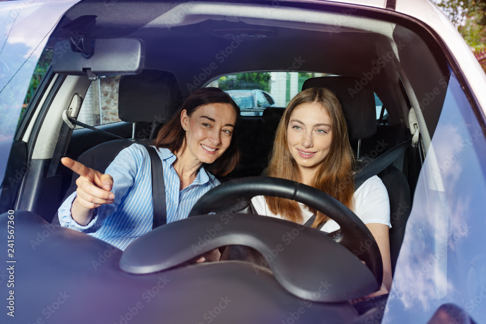 Teenage girl learning to drive with her mother Stock Photo | Adobe Stock