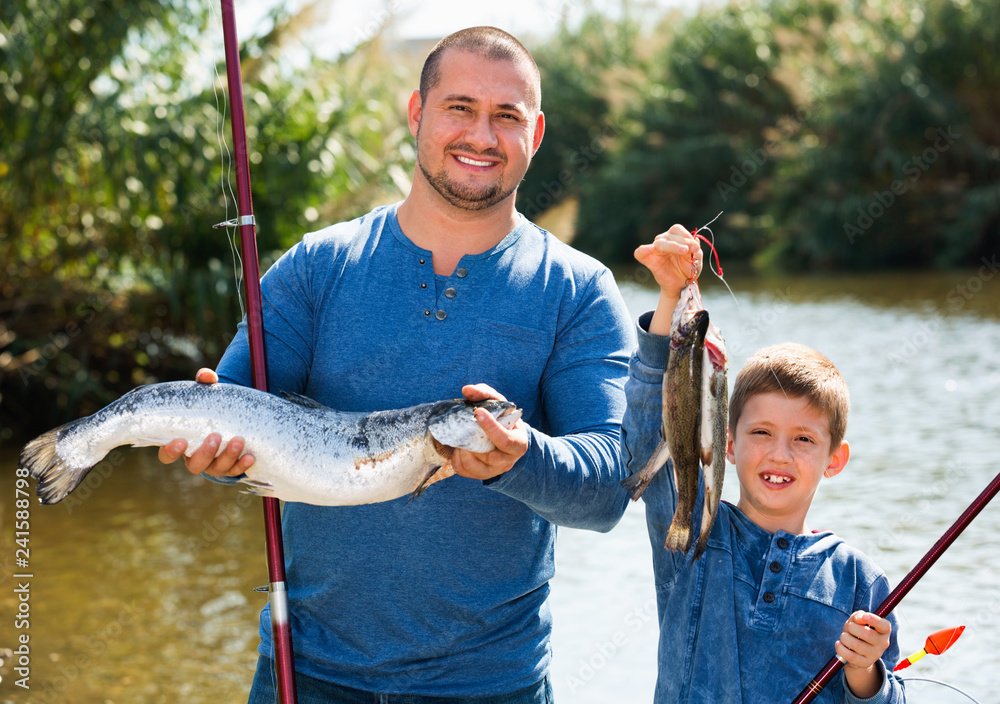 Portrait of father and son fishing with rods Stock Photo | Adobe Stock