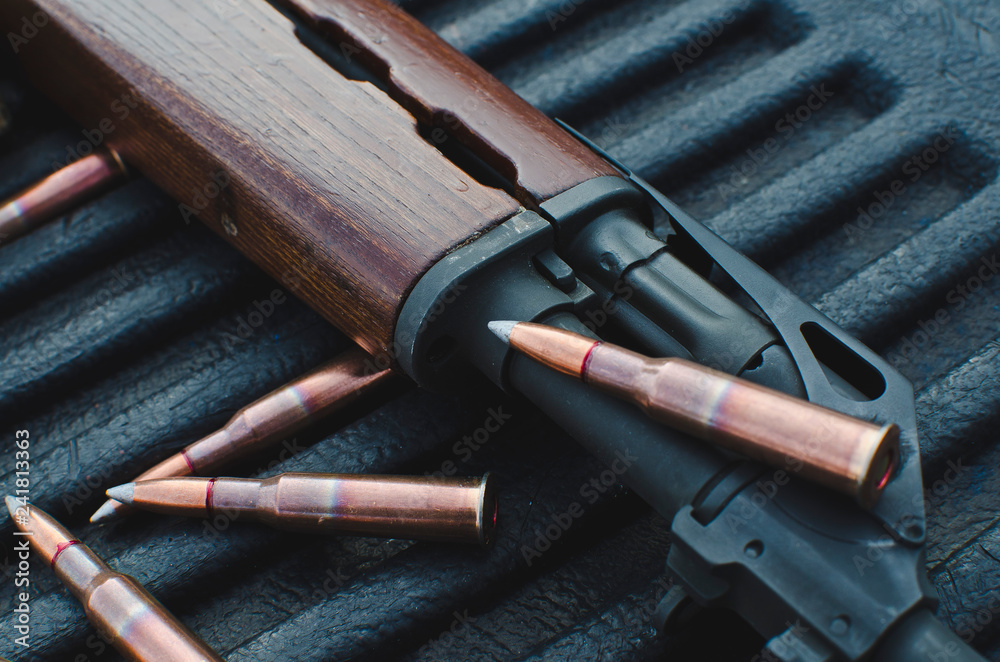 The handle and barrel of the rifle with the rounds on the old range ...