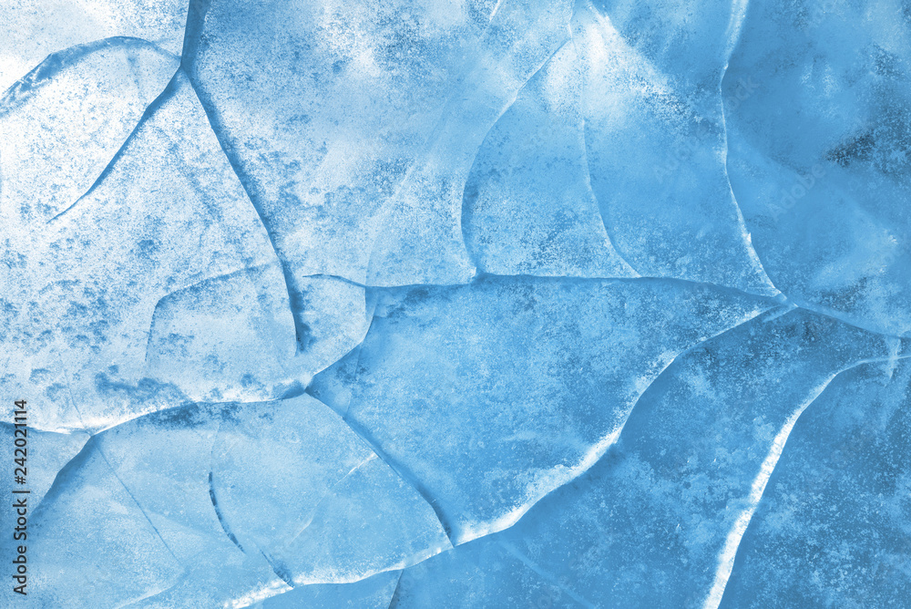 Abstract ice background. Blue background with cracks on the ice surface ...
