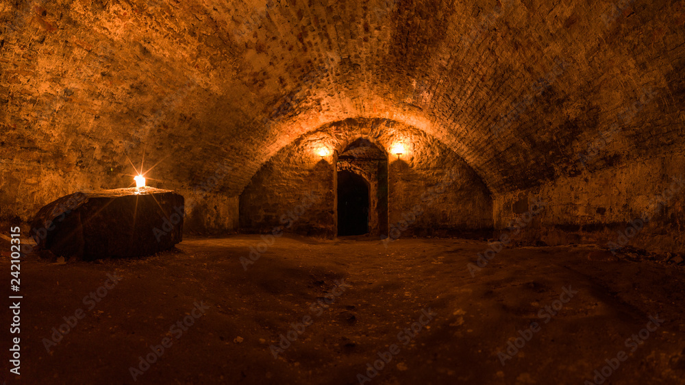 Scottish underground dungeon halls lit only by torchlight Stock Photo ...