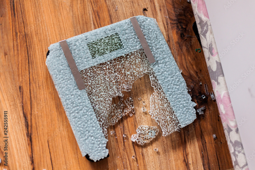Broken digital human scale on the floor. Broken glassy digital scale ...