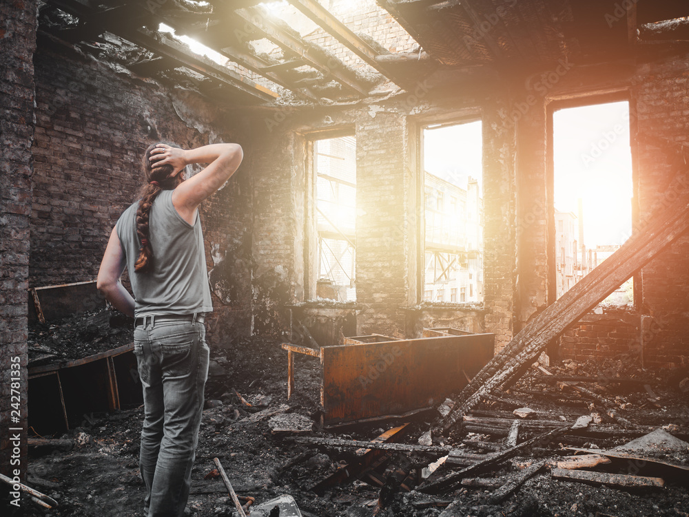 Man house owner stands inside his burnt house interior with burned ...