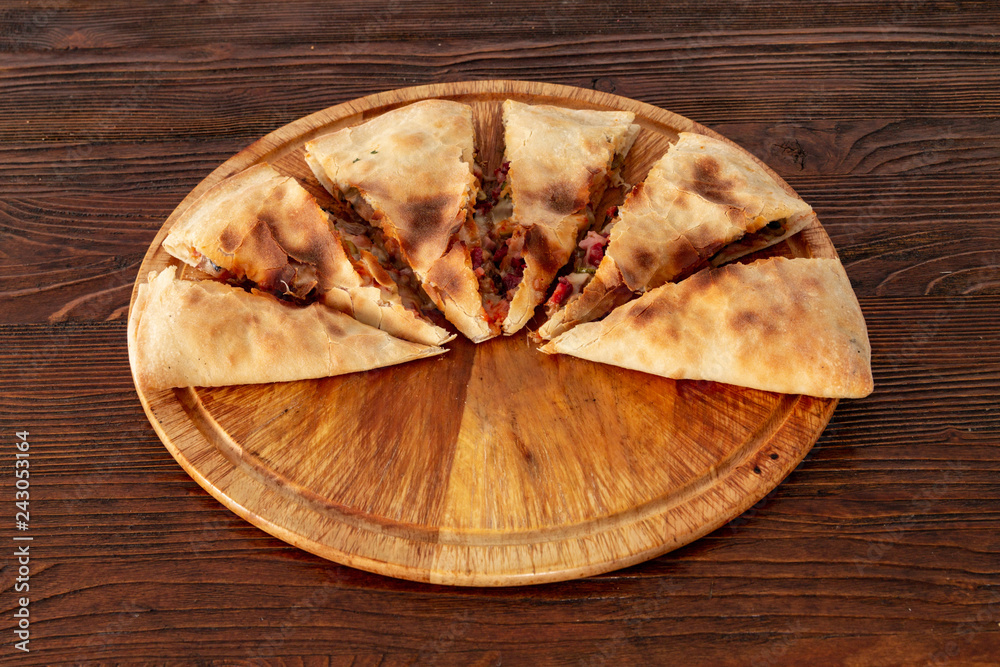Pizza calzone on the textured table, for the restaurant menu, cafe ...