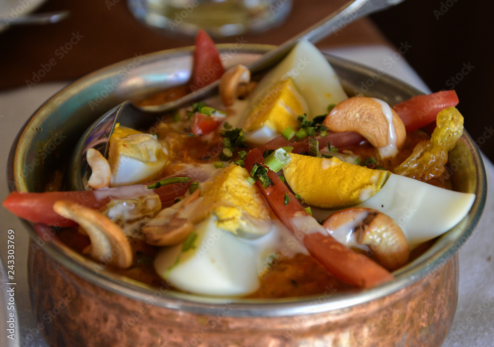 Delicious Indian cuisine in a bronze pot. Traditional North-Indian ...