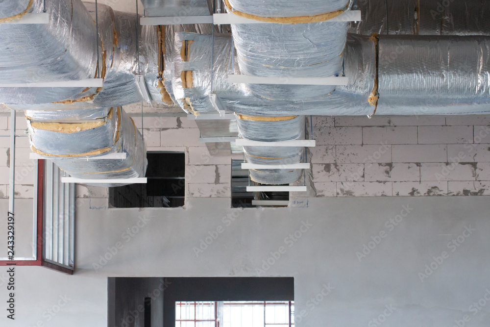 Typical installation of ducting with fiberglass insulation work pass ...