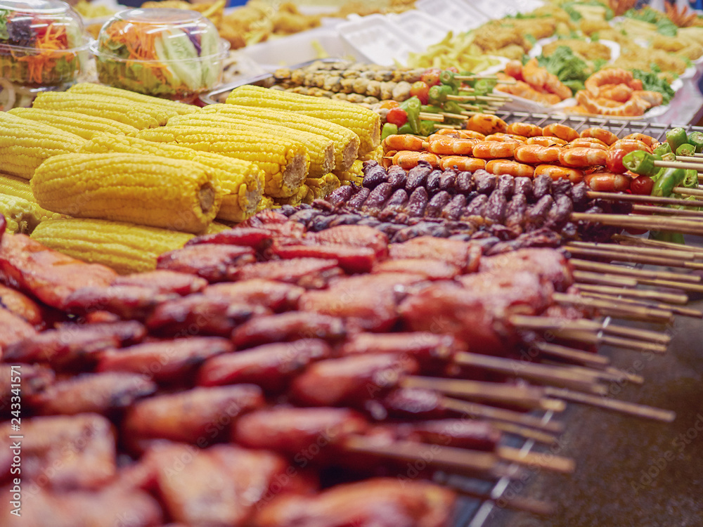 Street food on sticks in Phuket (Thailand). Corn cobs, pork, chicken ...