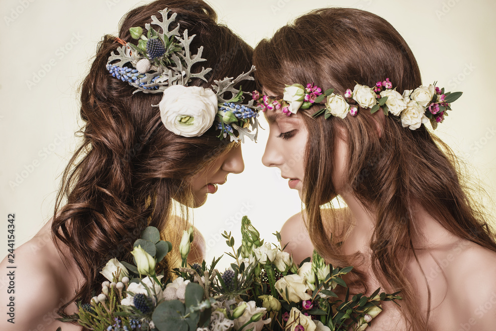 Spring, summer fashion photo shoot at the studio.Two beautiful girls ...
