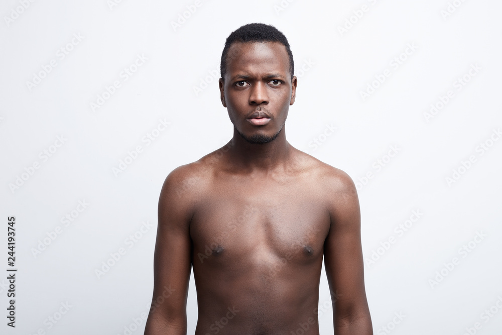 Close up shot of serious dark skinned male with scared and anxious ...