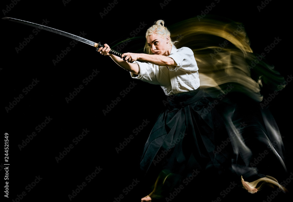one bodokas fighters woman practicing Iaido Kenjutsu studio shot ...