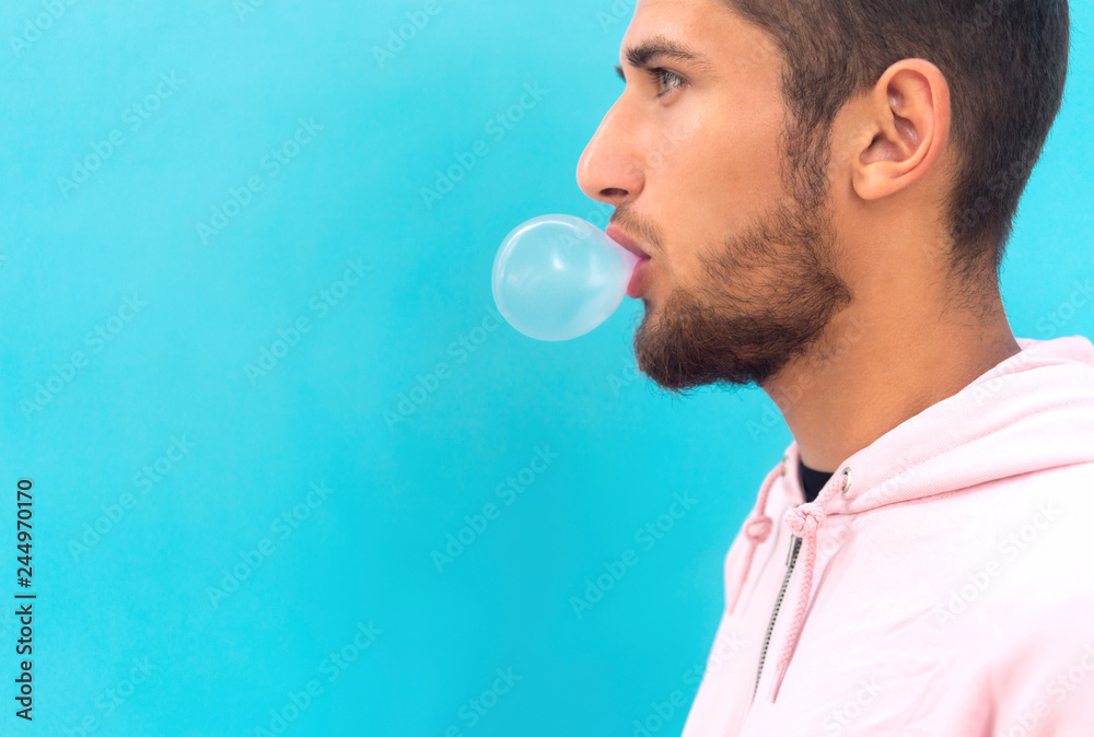 Handsome cheerful hipster bearded teen man with bubblegum , blowing ...