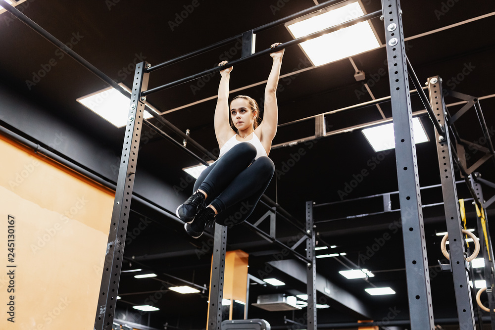 Bottom view - a strong athletic young champion female works with her ...