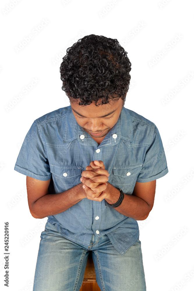 Young Indo Mauritian Or Creole Pastor In Training Sitting With Hands In
