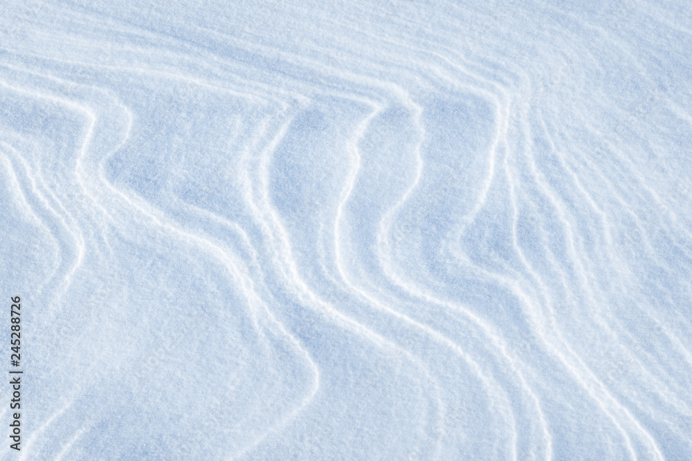 Winding lines from the wind in the snow. Texture of crusty snow. Winter ...
