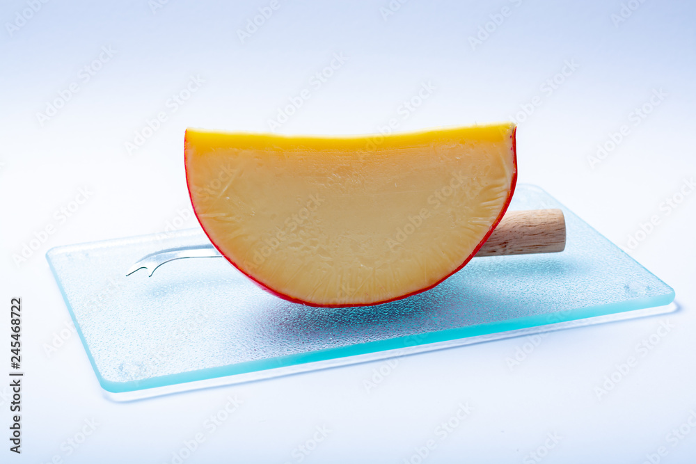 One piece of traditional Dutch red ball Edam cheese Stock Photo | Adobe ...