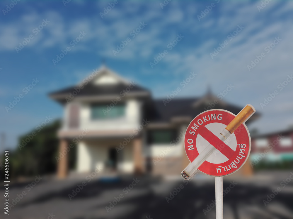no smoking sign with english and thai wording on blur house background ...