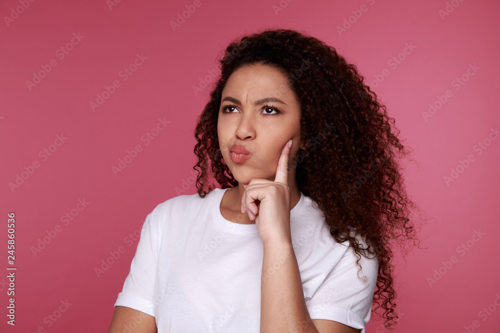 Isolated portrait of stylish young mixed race woman with dark shaggy ...