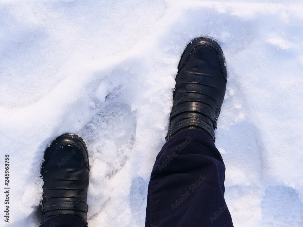 Person's feet in leather boots walking in the snow in winter Stock ...